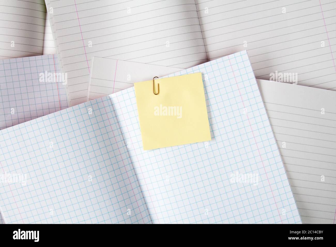 Blank exercise books with sticky note Stock Photo - Alamy