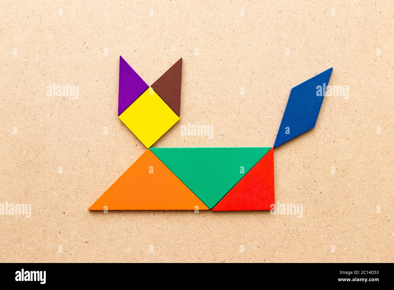 Color tangram puzzle in cat shape on wood background Stock Photo - Alamy