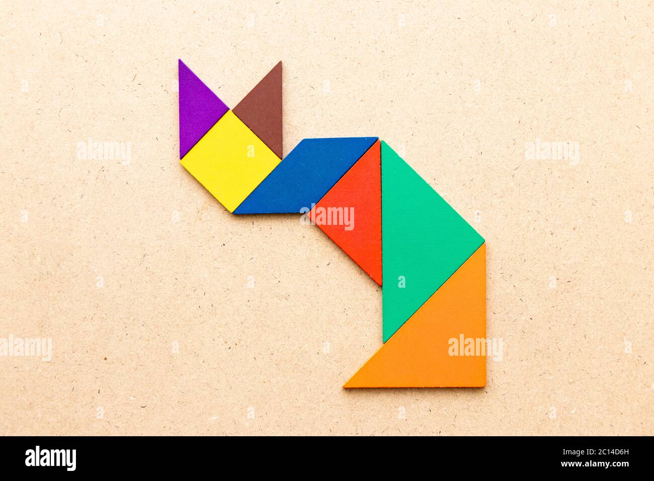 Color tangram puzzle in cat shape on wood background Stock Photo - Alamy