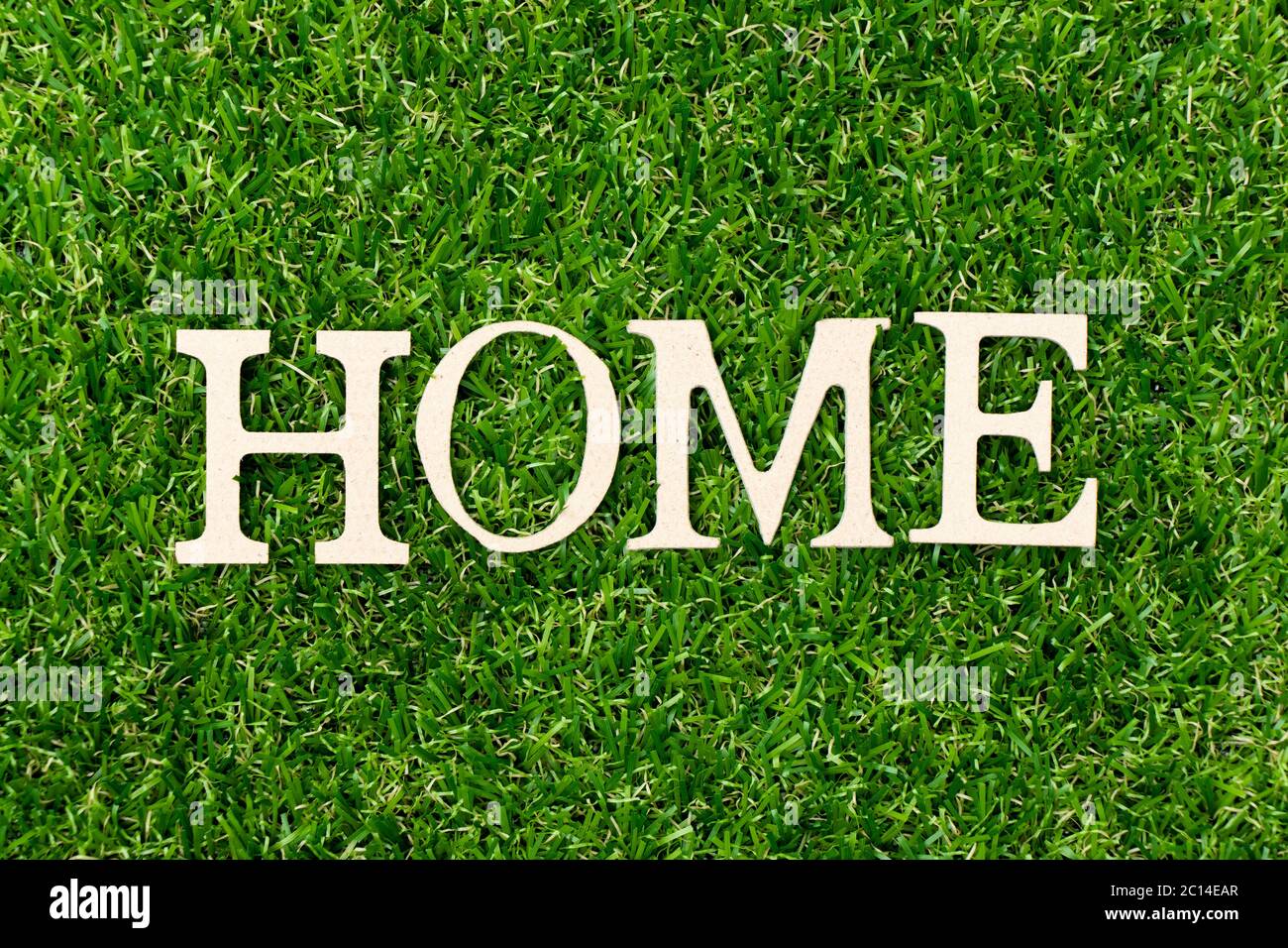 Wood letter in word home on green grass background Stock Photo - Alamy