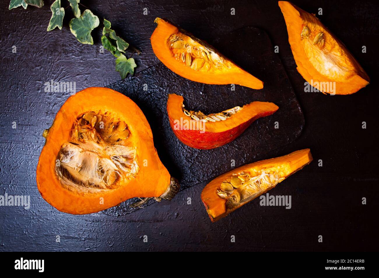 Fresh opened pumpkin on a dark table top view Stock Photo - Alamy