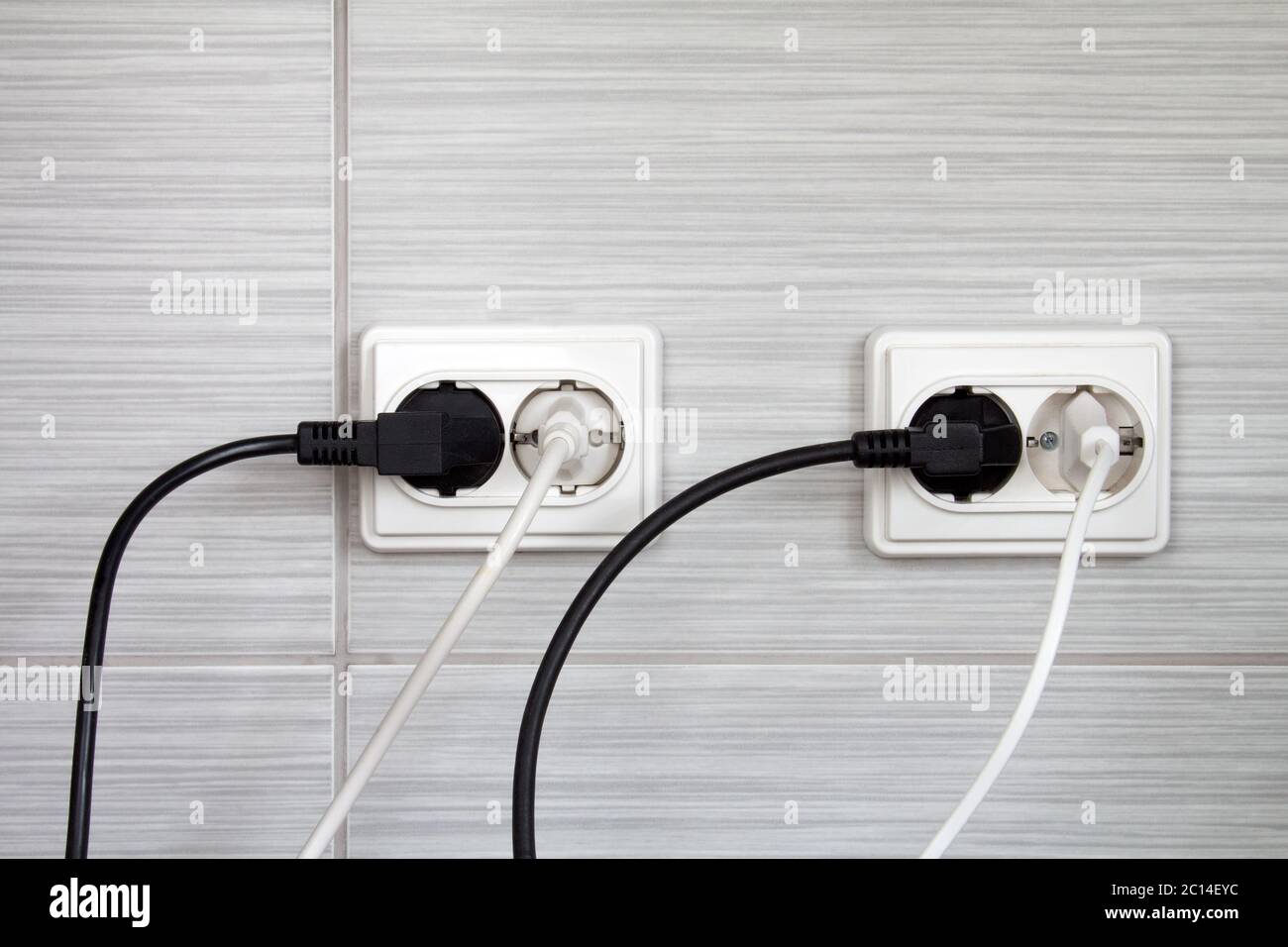 Electrical outlets with cables plugged Stock Photo - Alamy