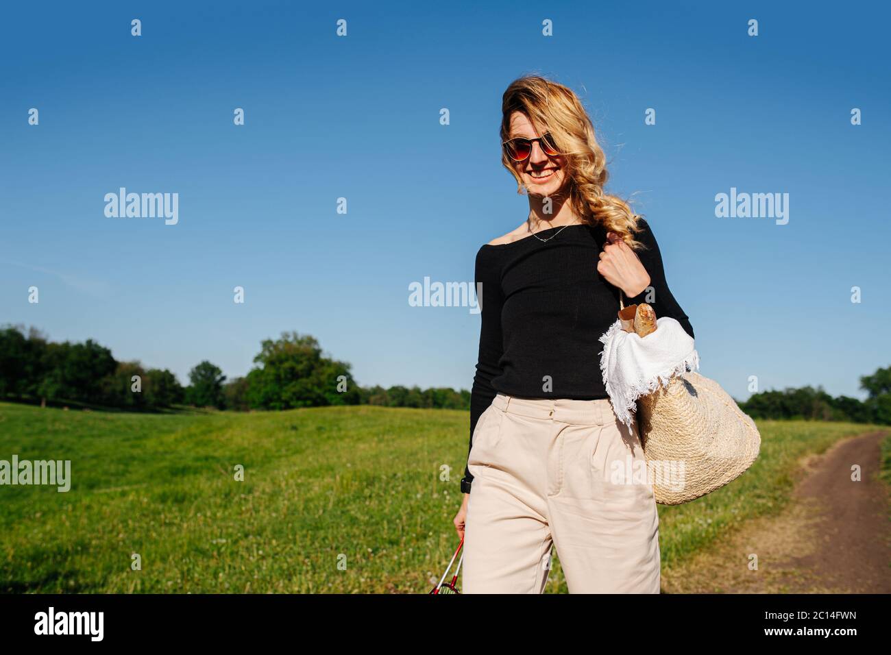 Woman in countryside walking and giving a big smile Stock Photo - Alamy