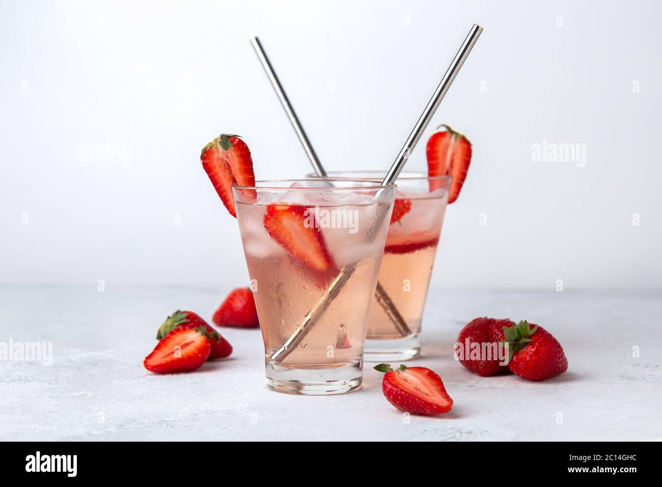 Iced fruit tea with strawberries and ice on a white background Stock ...