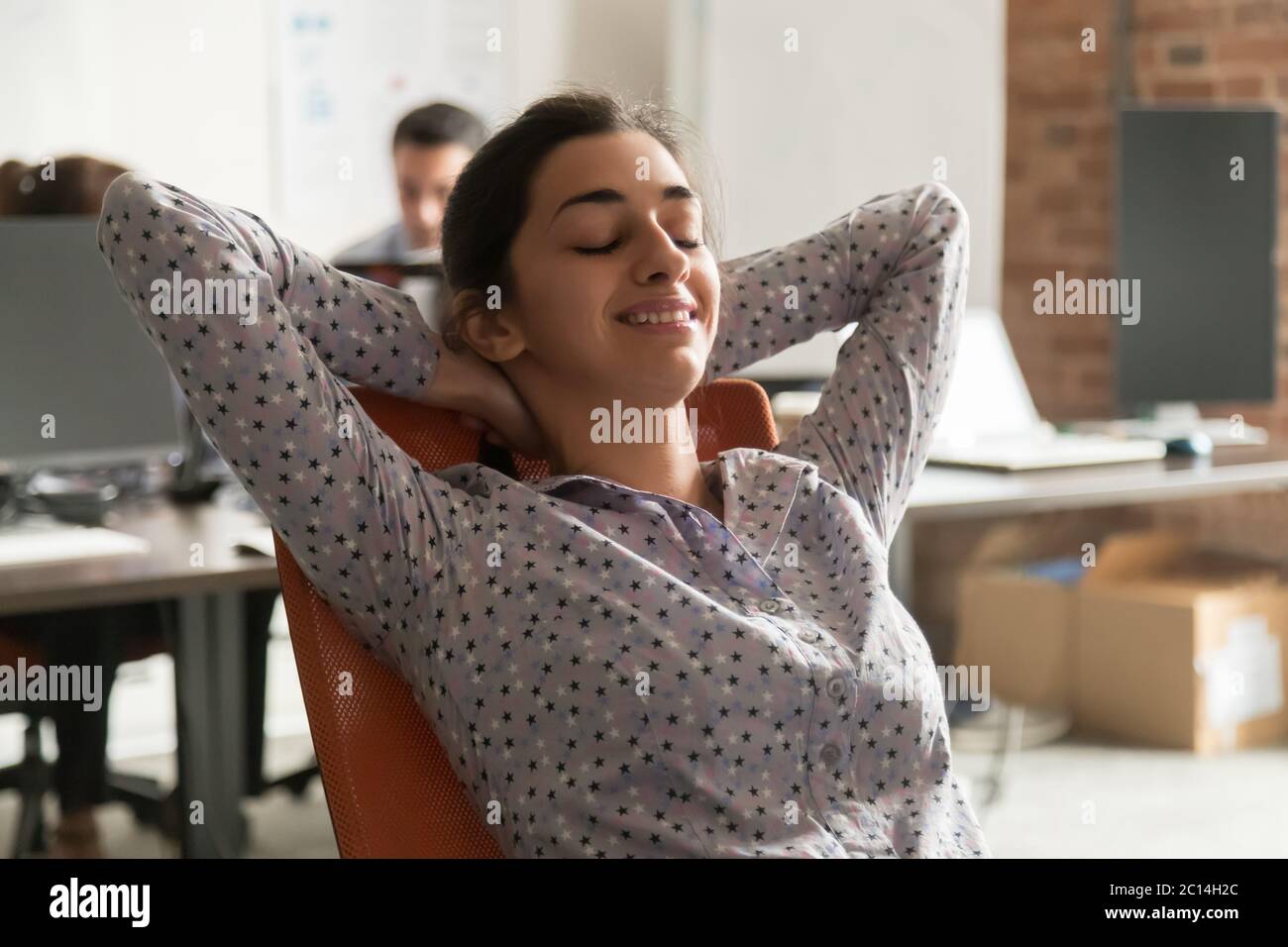 Calm Indian businesswoman employee relaxing in comfortable office chair ...