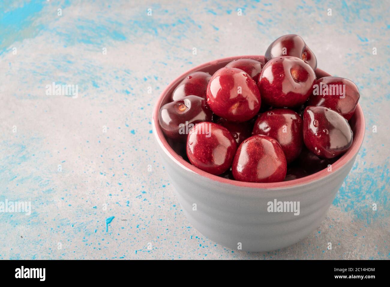 closeup fresh ripe cherry fruits in a bowl on table with copy space ...