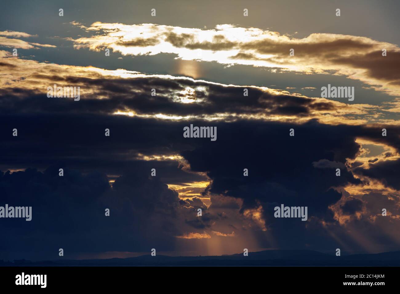 Crepuscular rays breaking through the cloud-cover Stock Photo - Alamy