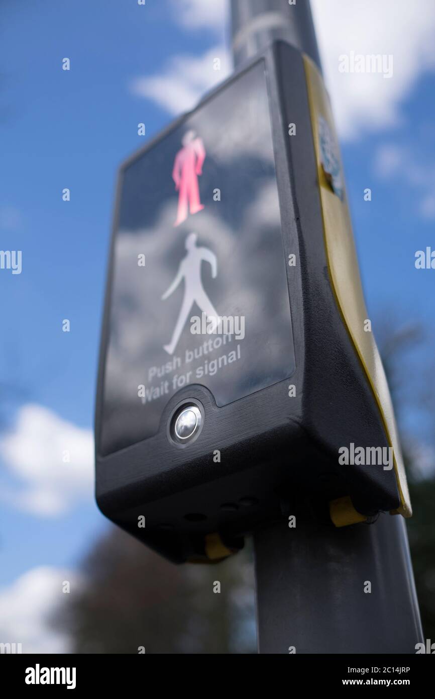 Crosswalk button for pedestrians with light warning in the UK. The ...