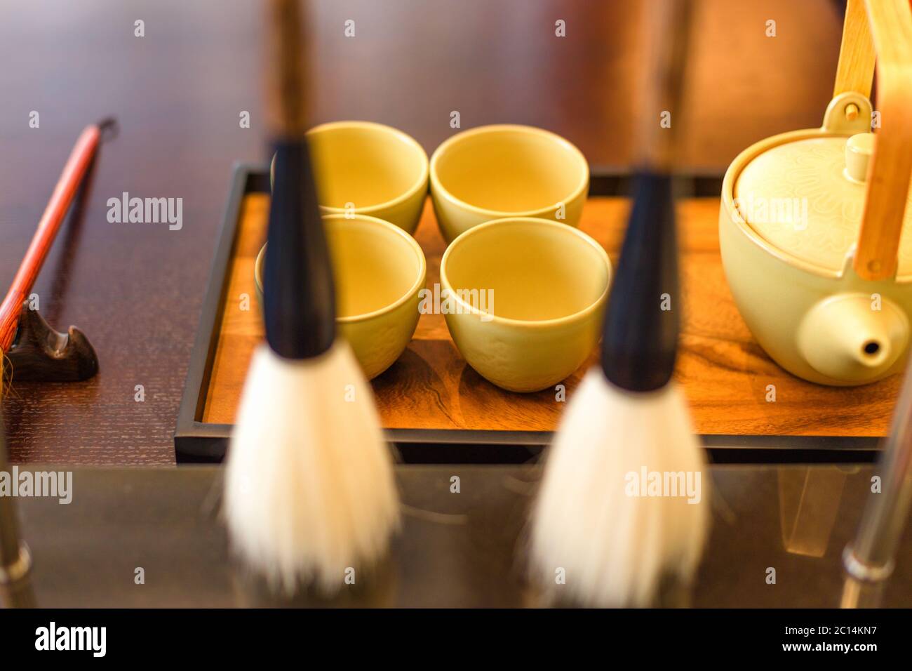 elegance tea set and calligraphy brush on table Stock Photo - Alamy