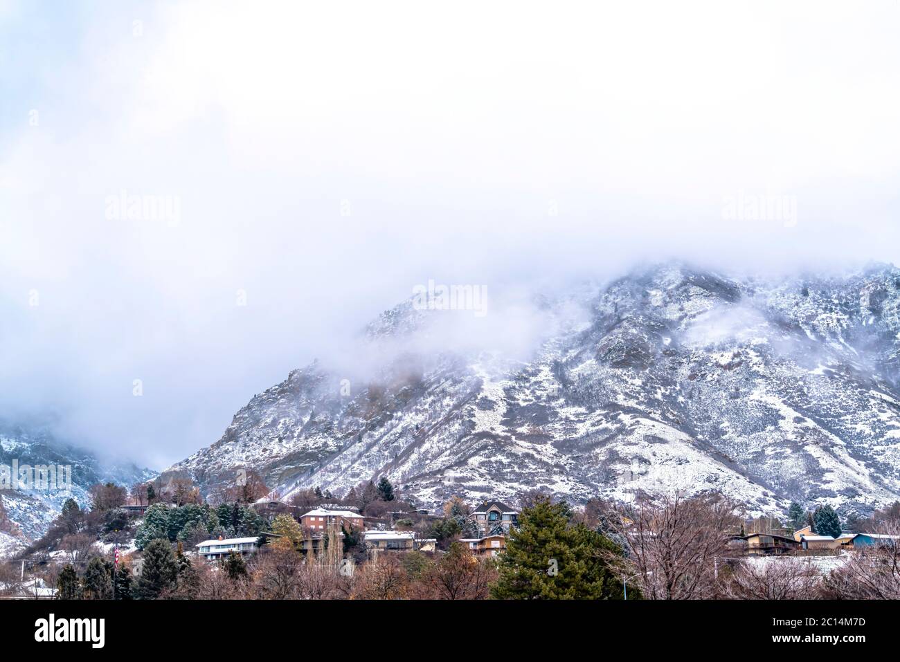 Rocky Provo Canyon in Utah blanketed with thick clouds and dusted with ...