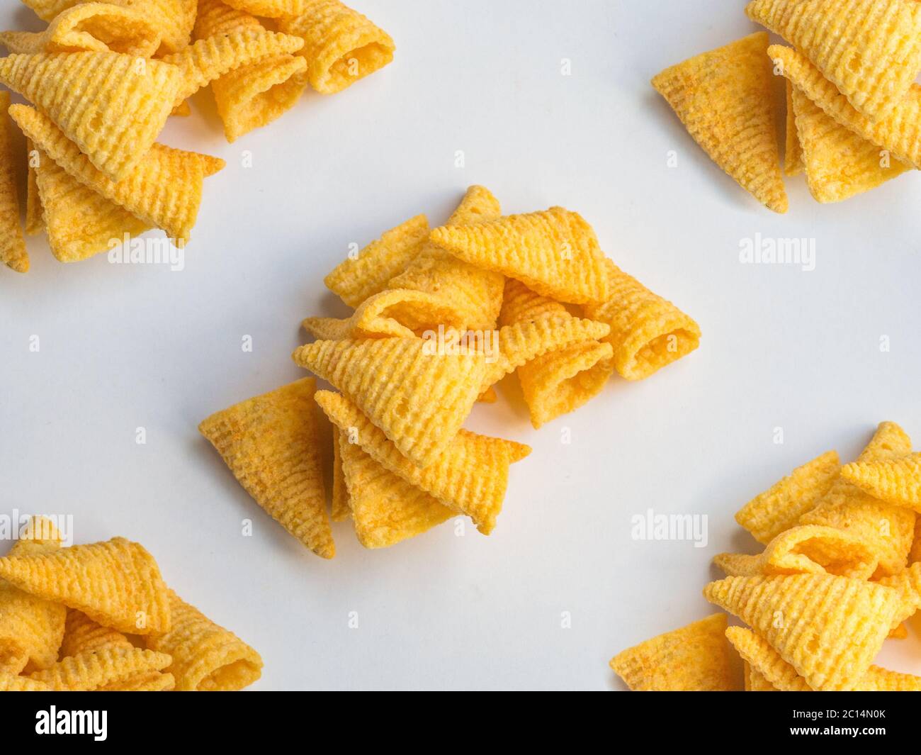 Corn cones pile pattern on white background Stock Photo - Alamy