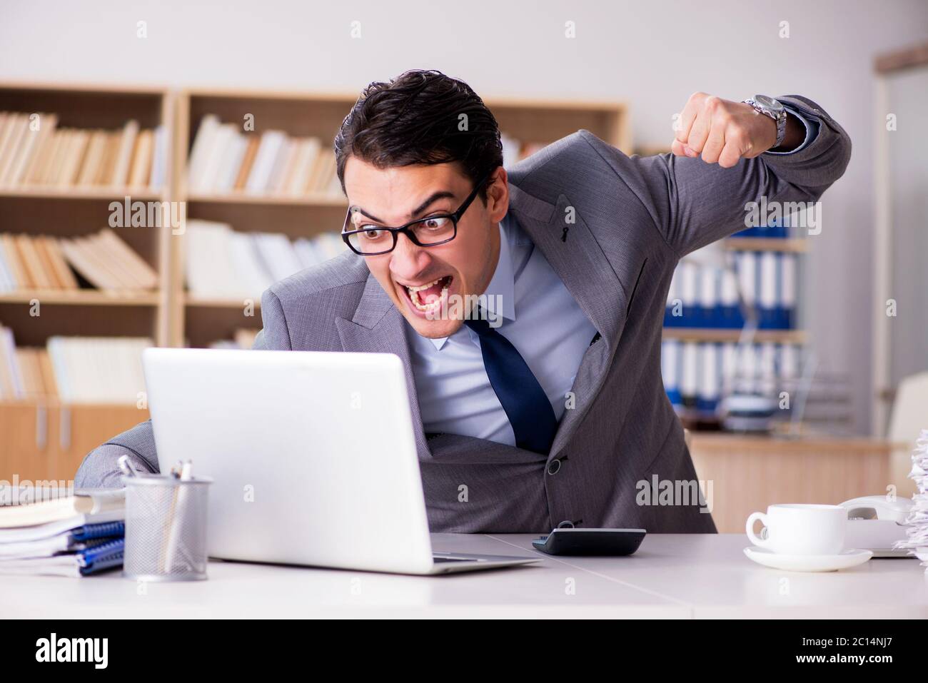 Angry businessman working in the office Stock Photo - Alamy