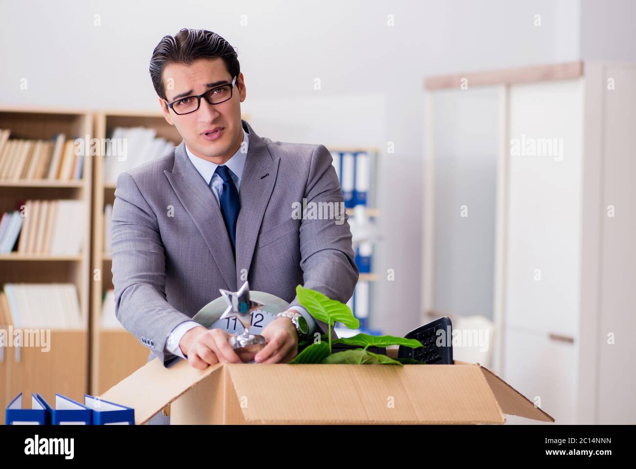 Man moving office with box and his belongings Stock Photo - Alamy