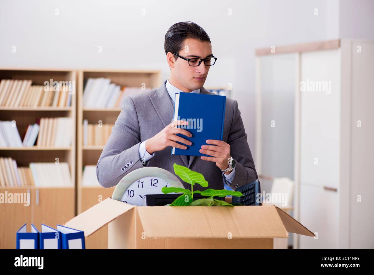 Man moving office with box and his belongings Stock Photo - Alamy