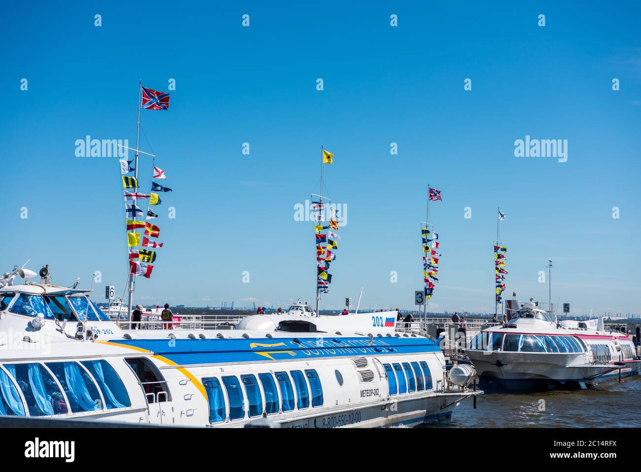 Colorful flags and cruise ship at the port of the summer palace of ...