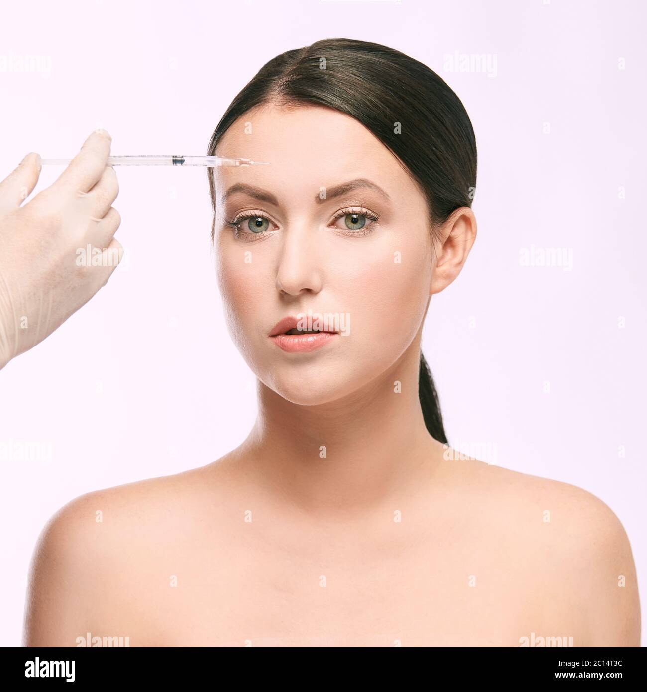 Face needle injection. Young woman cosmetology procedure. Doctor gloves ...