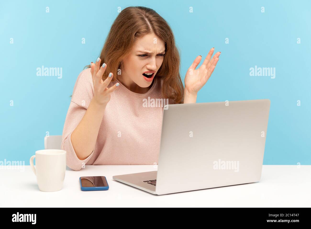 What do you want! Annoyed upset woman looking at laptop screen, talking ...