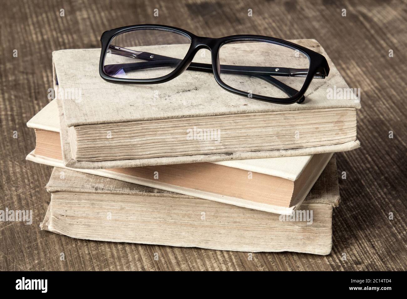 Stack of books with reading glasses Stock Photo - Alamy