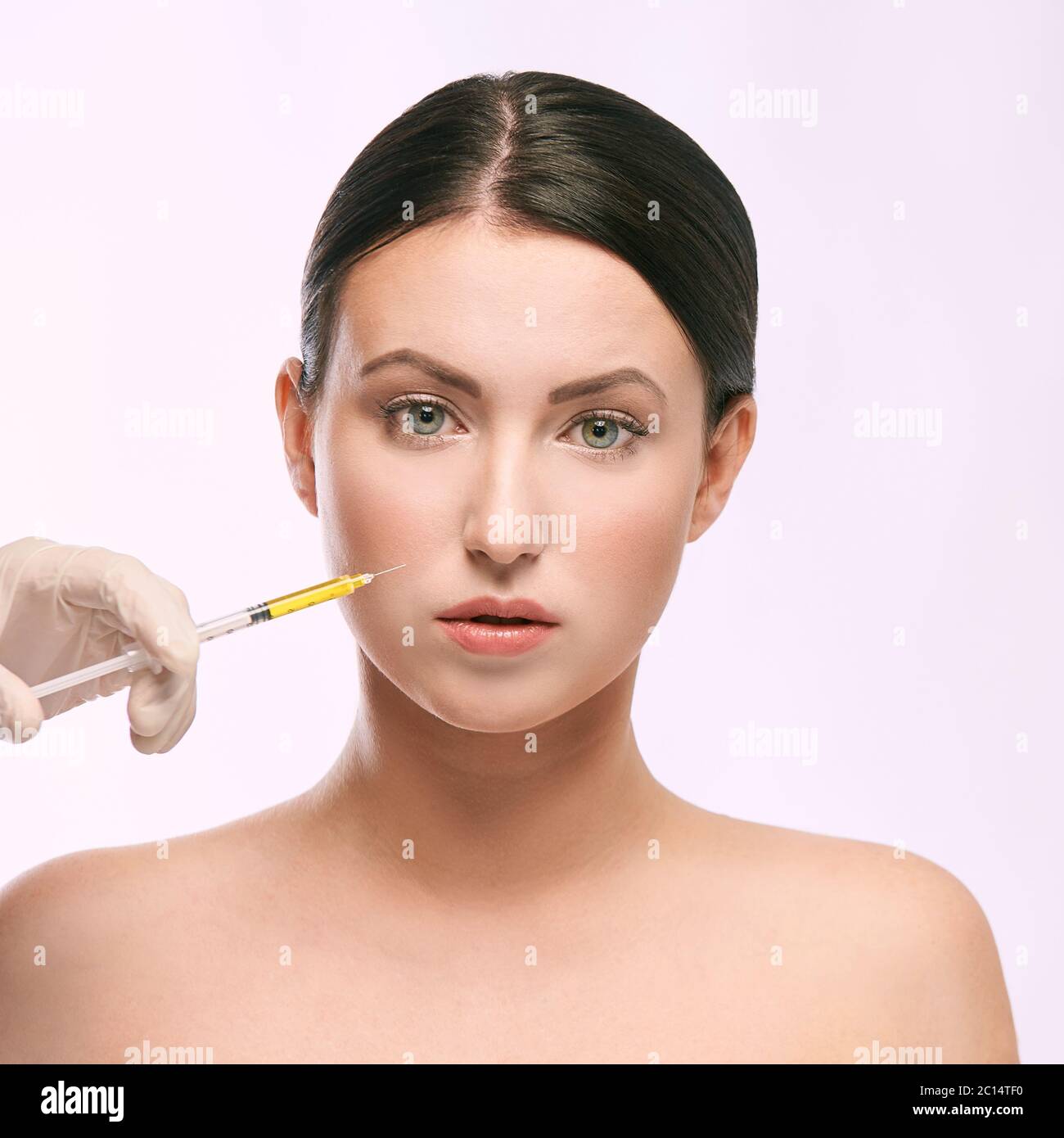 Face needle injection. Young woman cosmetology procedure. Doctor gloves ...