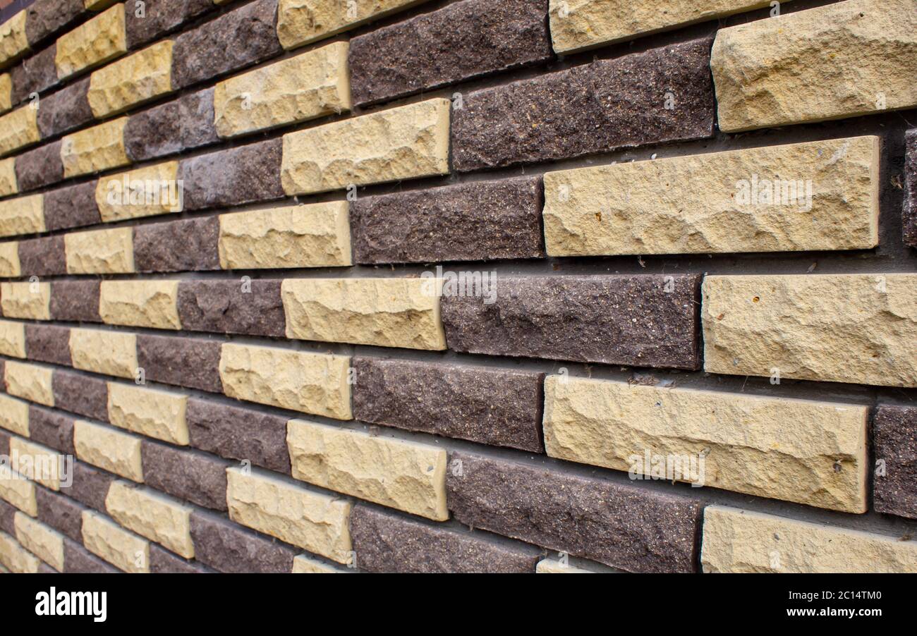 View at an angle on a wall of colored bricks close-up with blur for use ...