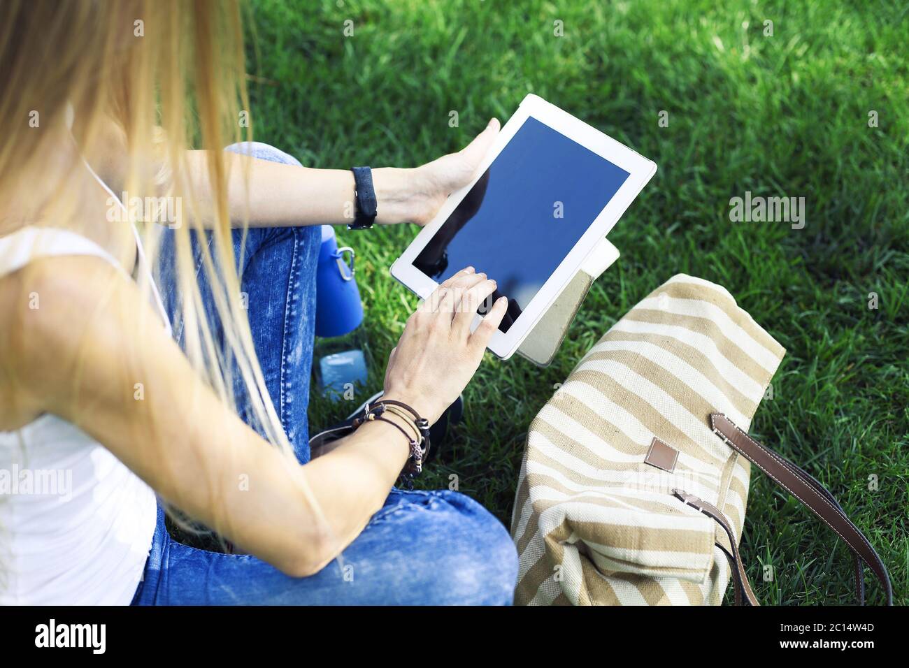 Table pc in a hand of girl on a nature background Stock Photo - Alamy