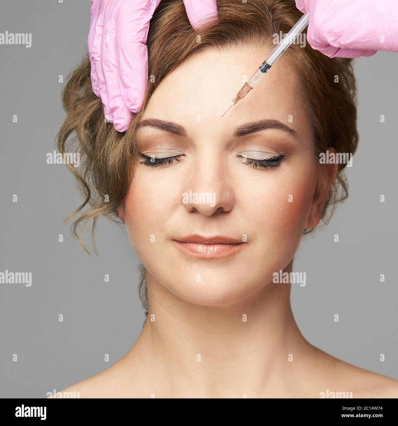 Face needle injection. Young woman cosmetology procedure. Doctor gloves ...