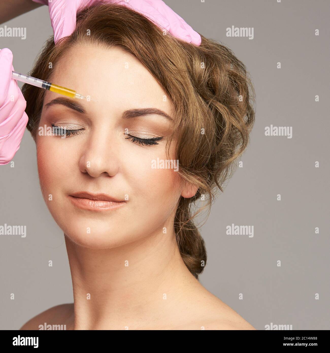 Face needle injection. Young woman cosmetology procedure. Doctor gloves ...