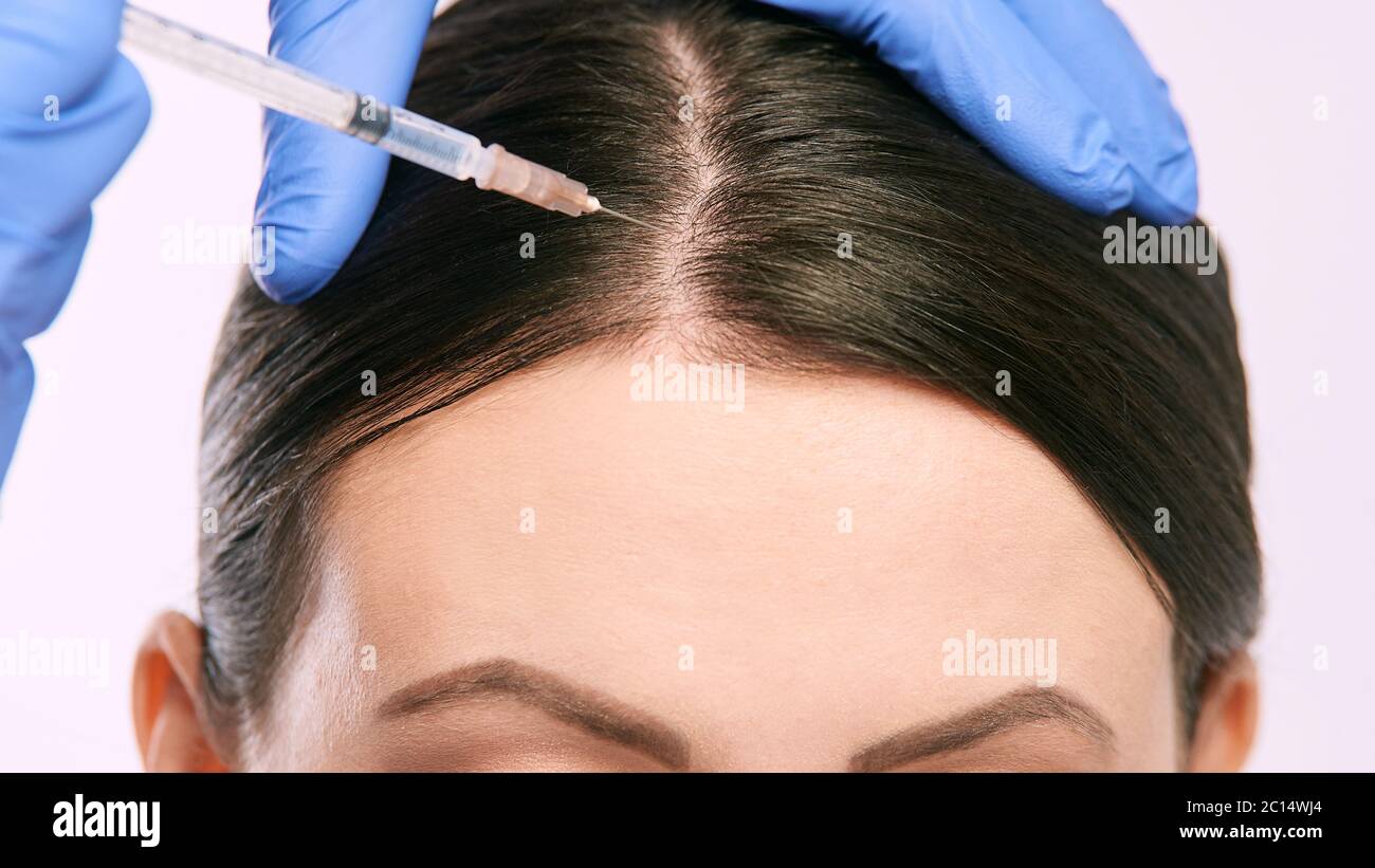 Face needle injection. Young woman cosmetology procedure. Doctor gloves ...