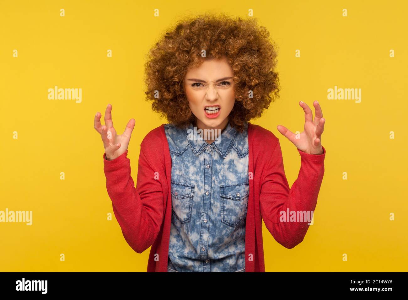 Aggressive emotions. Portrait of crazy irritated woman with curly hair ...