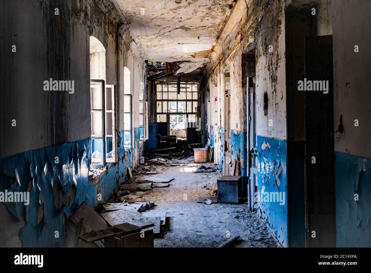 Ruined corridor with piles of garbage in abandoned building Stock Photo ...