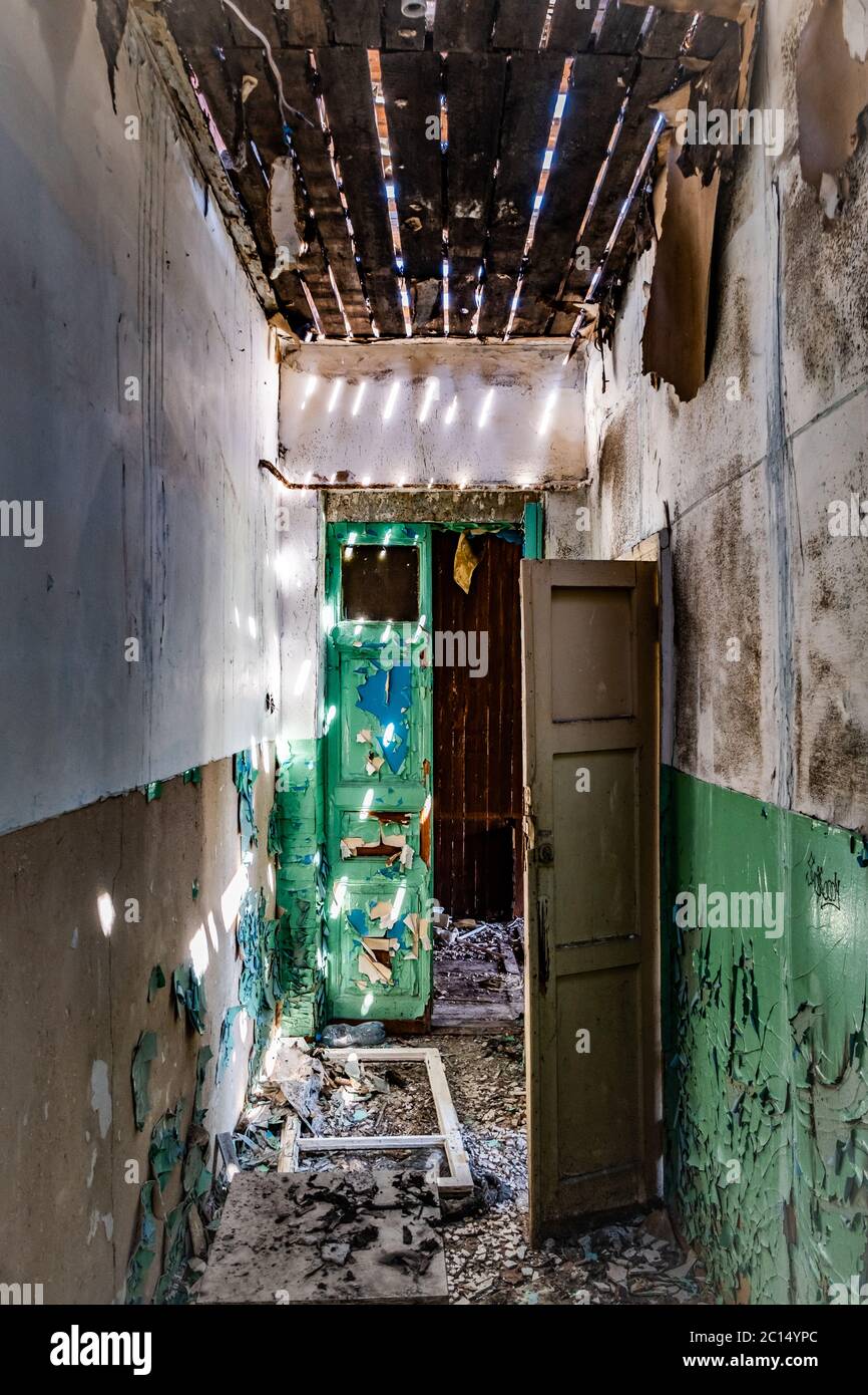 Ruined corridor with piles of garbage in abandoned building Stock Photo ...
