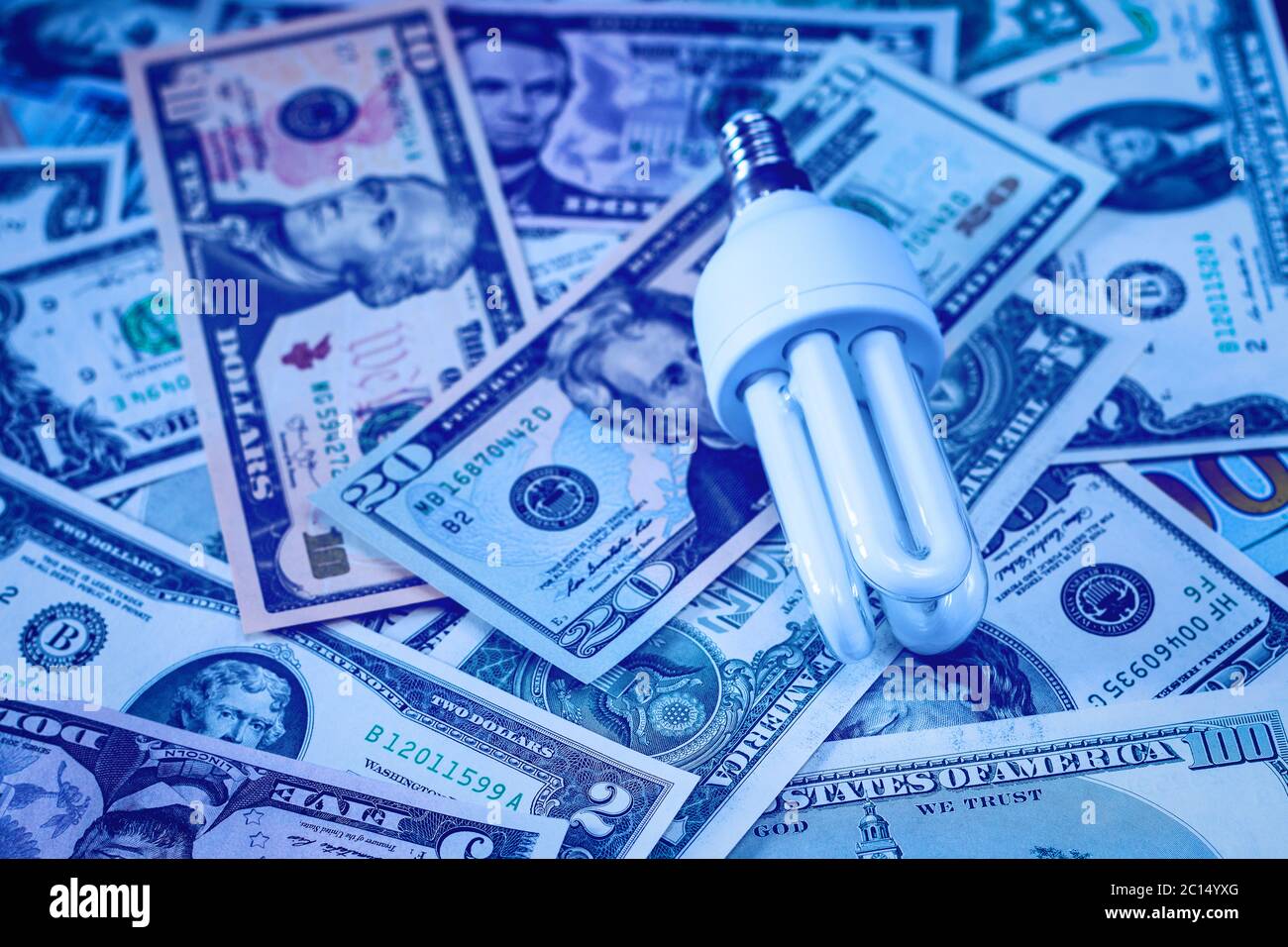 LED lamp on dollar bills background. The concept of saving money on ...