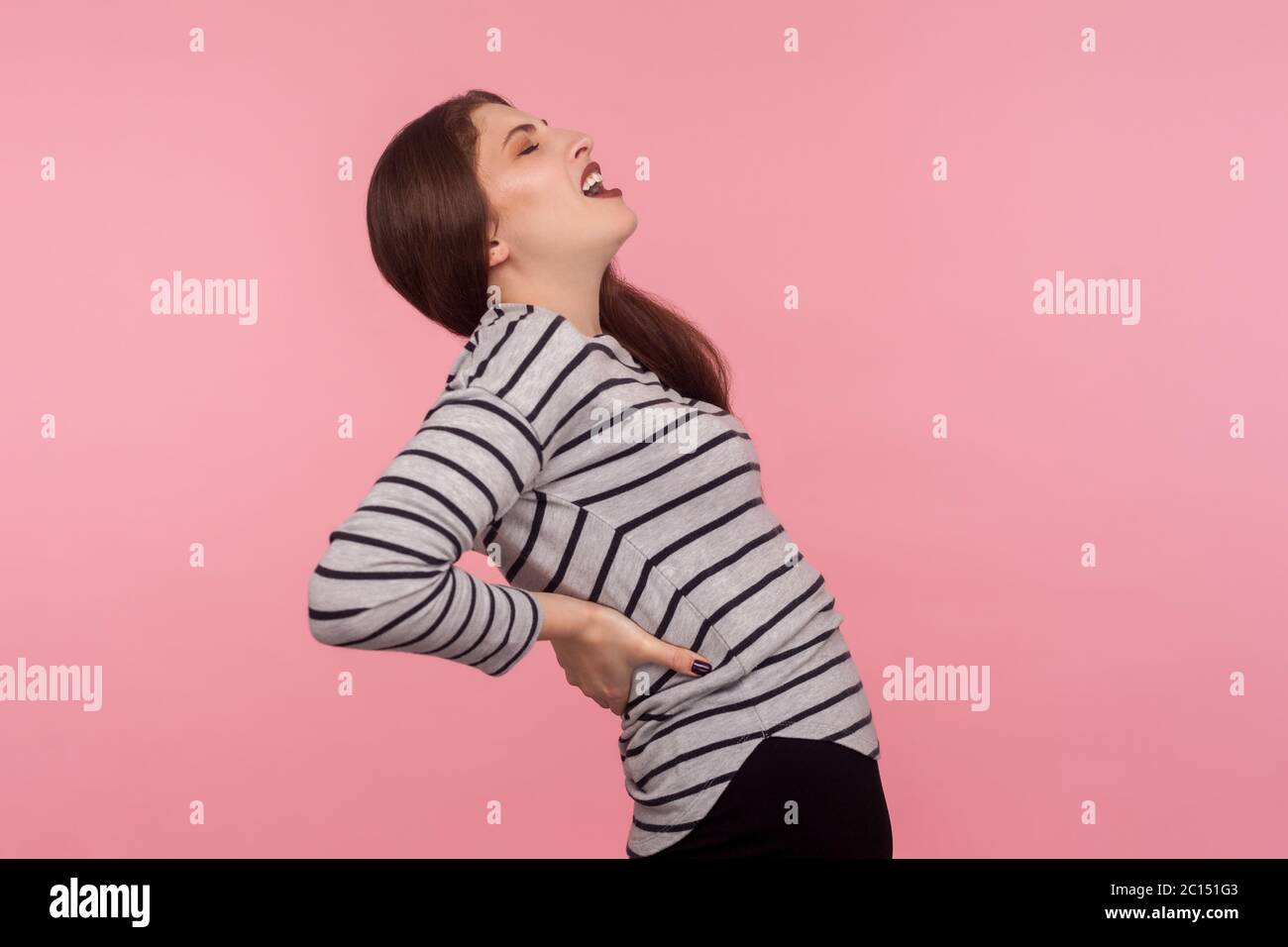 Portrait of unhealthy woman touching injured sore back, screaming in ...