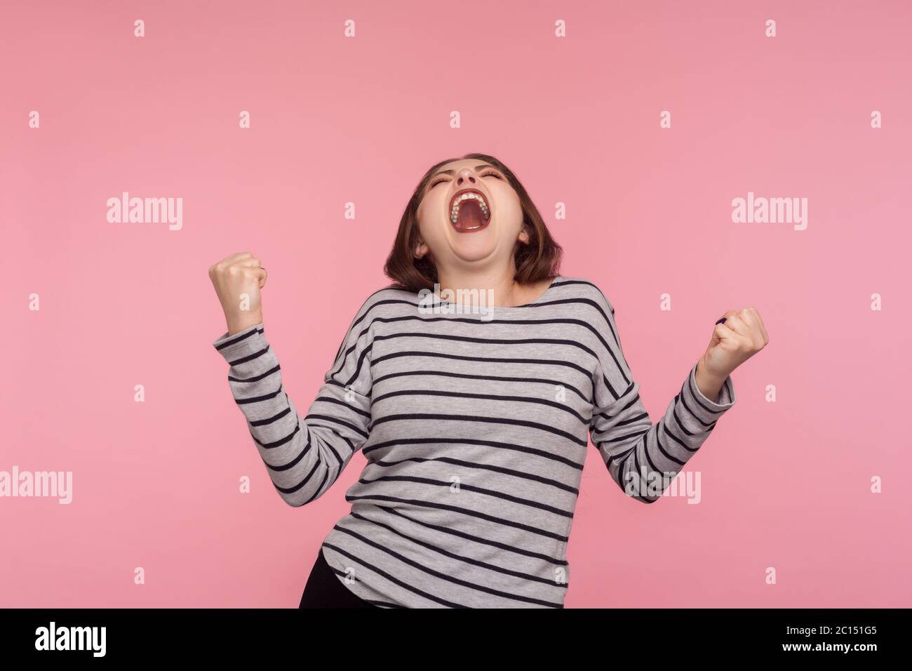 Triumphal victory! Portrait of extremely happy, overjoyed woman in ...