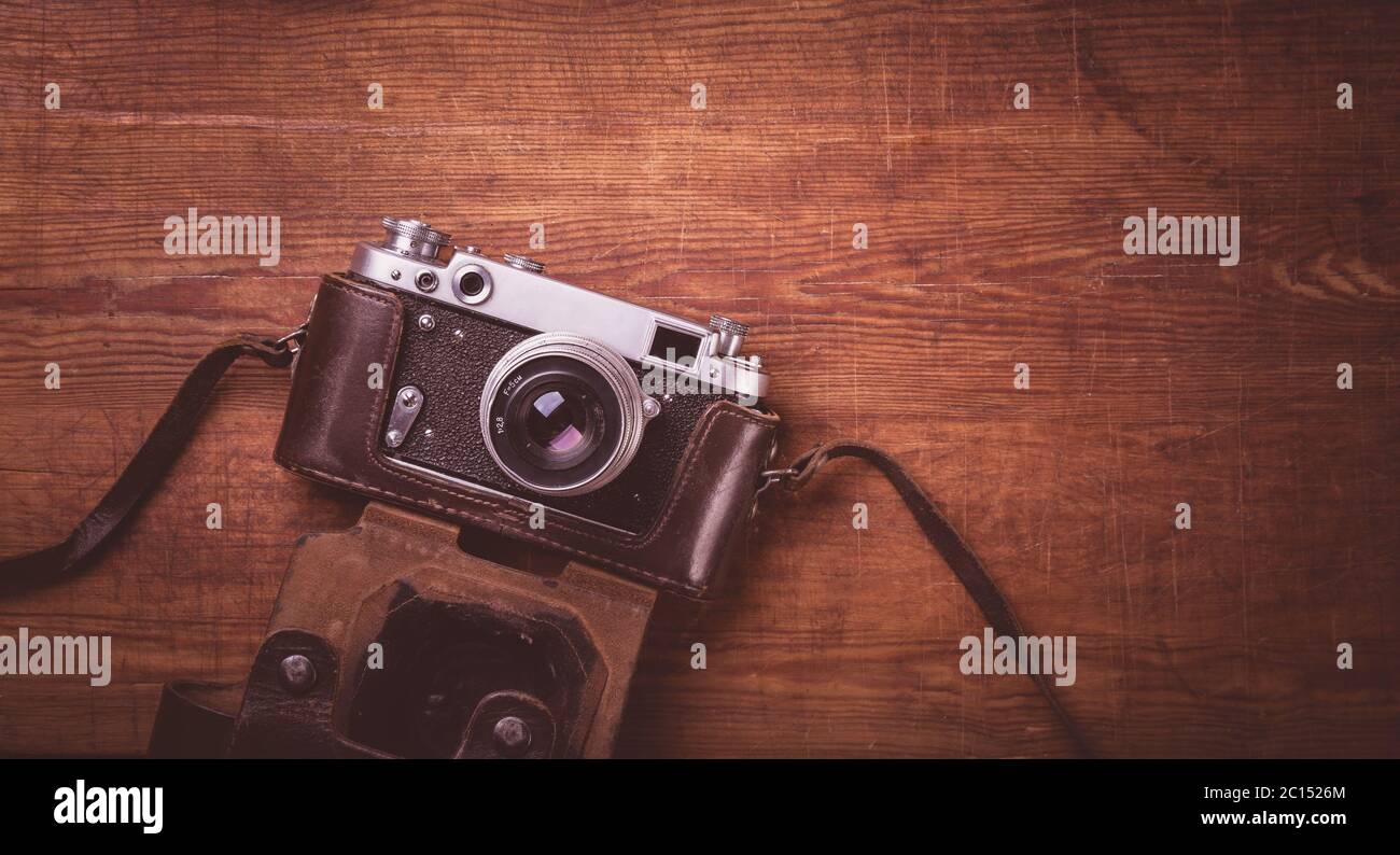 Retro camera on wood table background vintage color tone Stock Photo ...