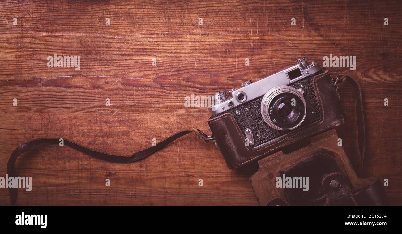 Retro camera on wood table background vintage color tone Stock Photo ...