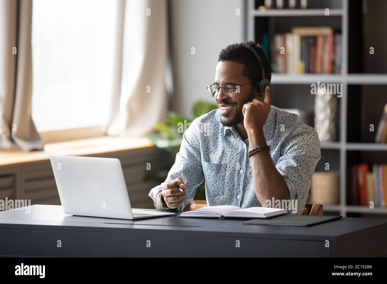 Businessman using laptop wearing headset hi-res stock photography and ...