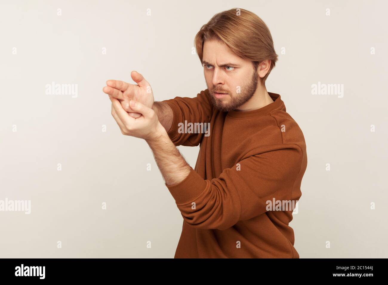 Aimed shot. Portrait of concentrated focused bearded man pointing ...