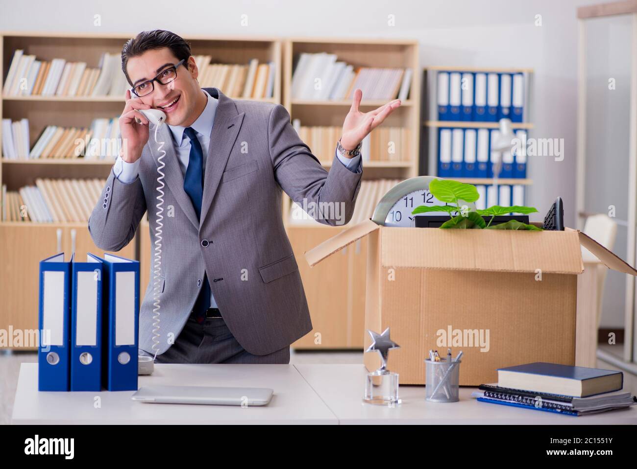 Man moving office with box and his belongings Stock Photo - Alamy