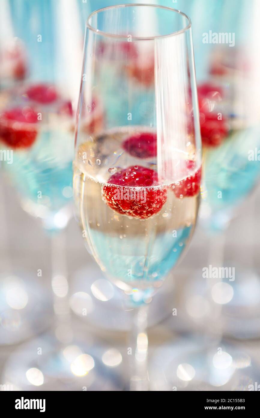 Champagne glasses with raspberry Stock Photo - Alamy