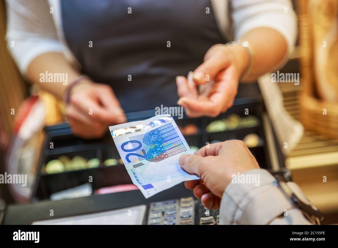 woman is paying In cash with euro banknotes Stock Photo - Alamy