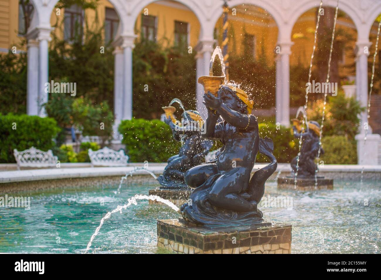 Angel playing trumpet in splashes of a fountain. Elements of a fountain ...