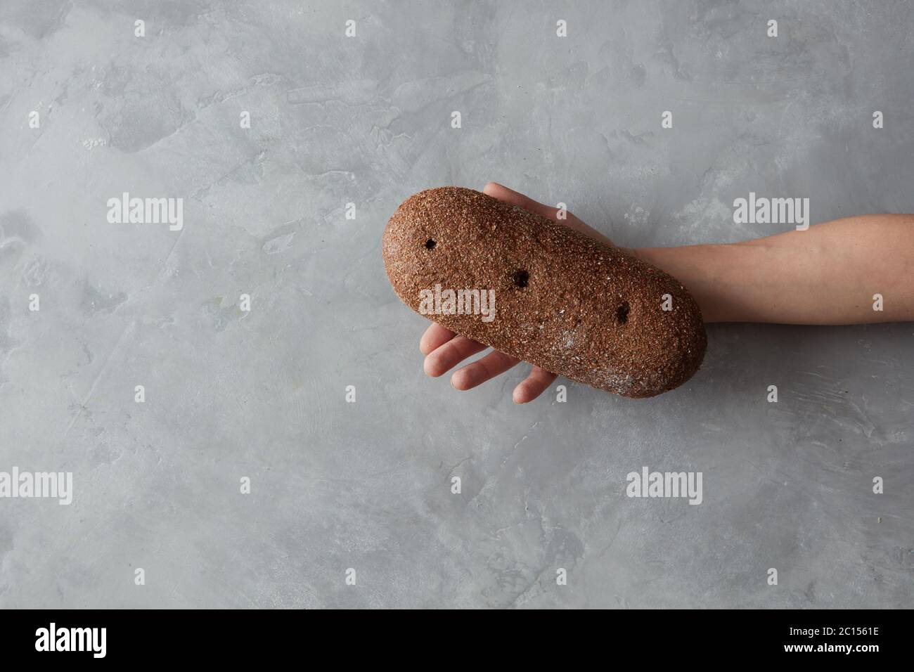 Loaf of bread in hand Stock Photo - Alamy