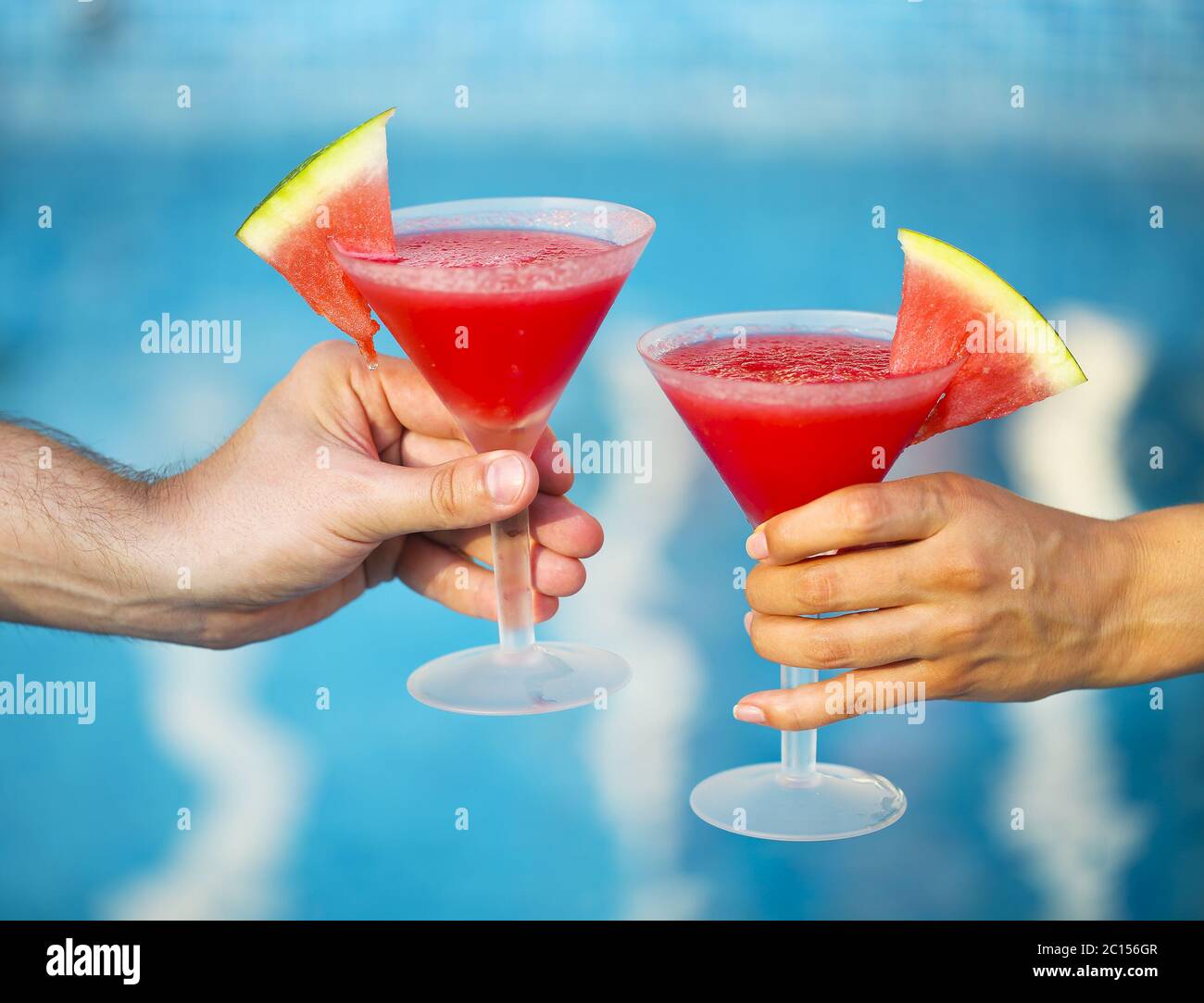 People hold watermelon cocktail near pool Stock Photo - Alamy