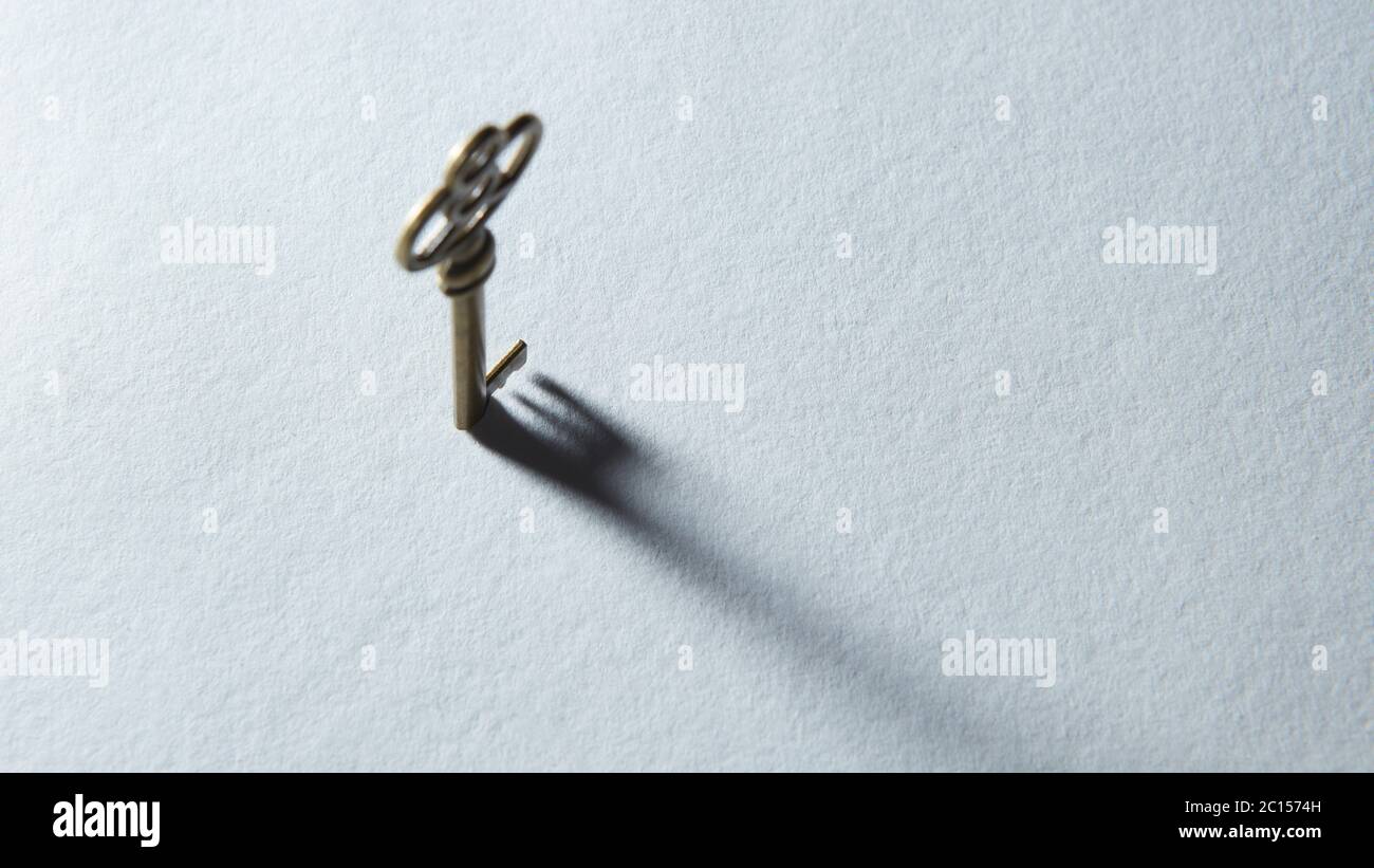 Vintage key with shadow Stock Photo - Alamy