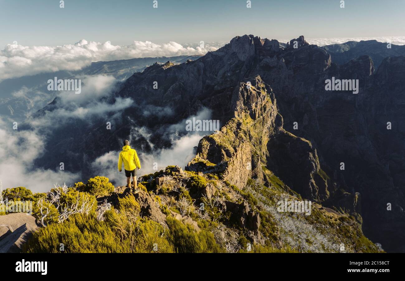 Man stands alone on the peak of rock. Beautiful moment the miracle of ...