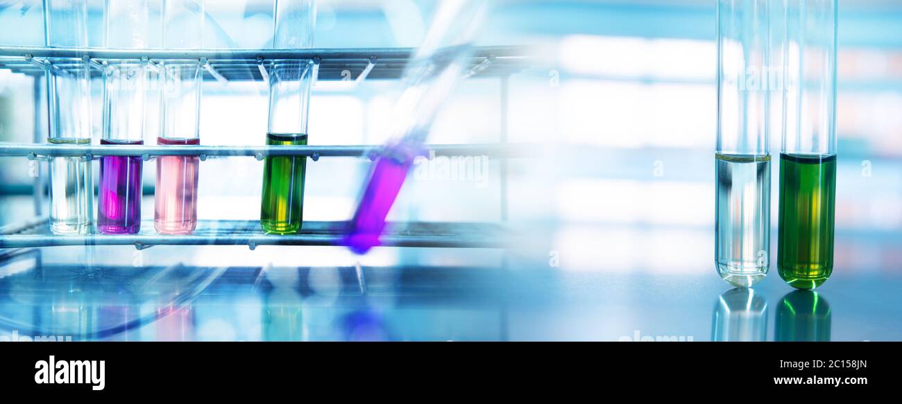 shaking colorful glass test tube in biochemistry science laboratory ...