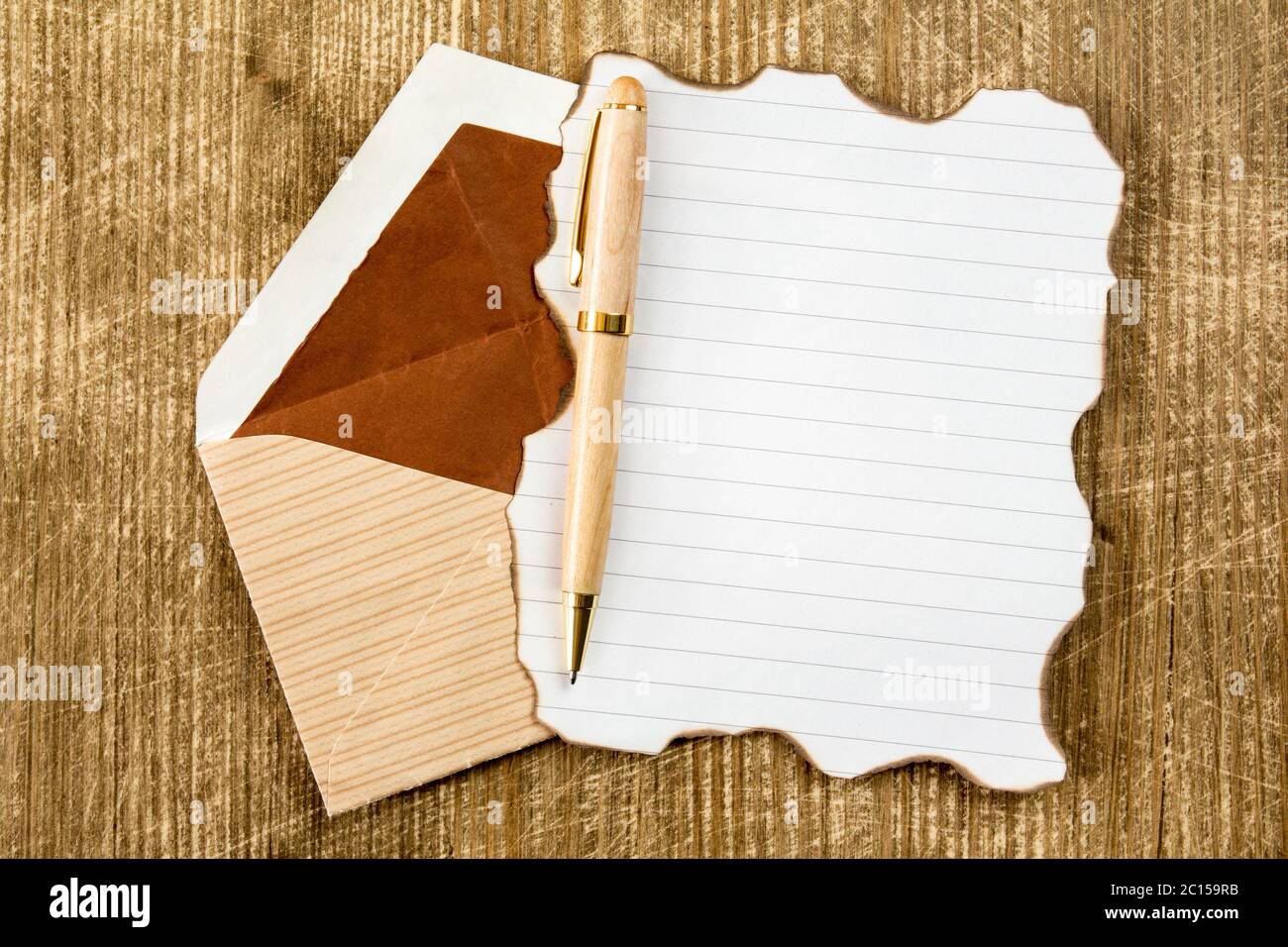 Open envelope with burned letter Stock Photo - Alamy