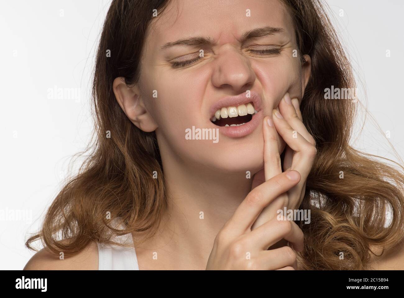 Young beautiful brunette girl on white background with toothache Stock ...