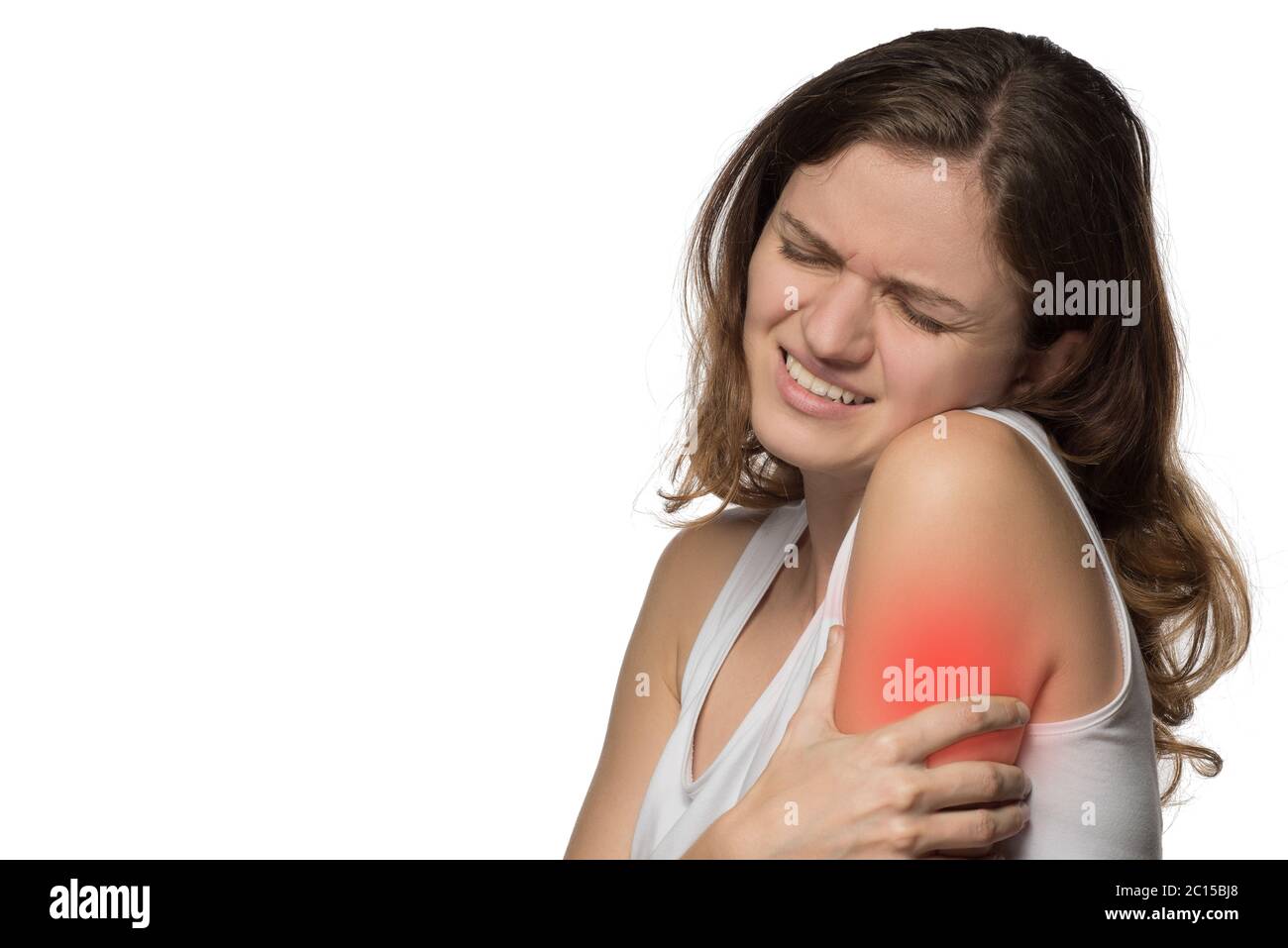 Beautiful brunette woman holding her hand over her shoulder because it ...